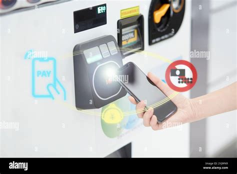 Woman Holding Her Smartphone Over The Ic Panel Of A Vending Machine