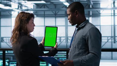 Computer Scientists In Data Center Use Mockup Tablet Inspecting Server