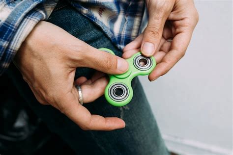 Premium Photo Midsection Of Man Holding Fidget Spinner