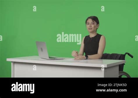 Live Tv News Program Asian Anchorwoman In A Wheelchair Reports News On Television Against The