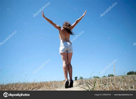 Rear View Unrecognized Topless Woman Arms Raised Countryside Stock