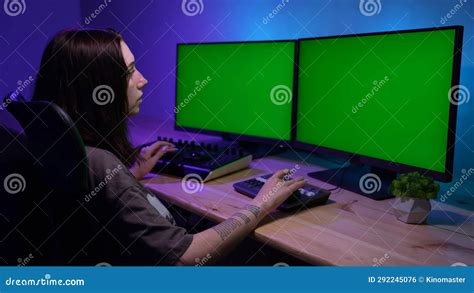 Portrait Of Female Model Looking At Monitors And Editing Video Using Special Equipment Stock