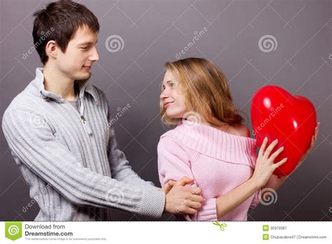 Two Young People Holding Heart Shaped Balloon Stock Image Image Of