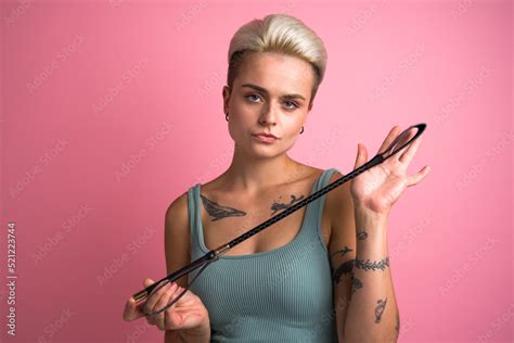 Confident Bdsm Woman Posing With Black Whip And Enjoying Dominance At