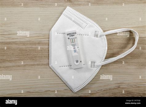 Ffp2 Mask Rapid Sars Cov 2 Antigen Test Cassette With Negative Test Result Wood Background