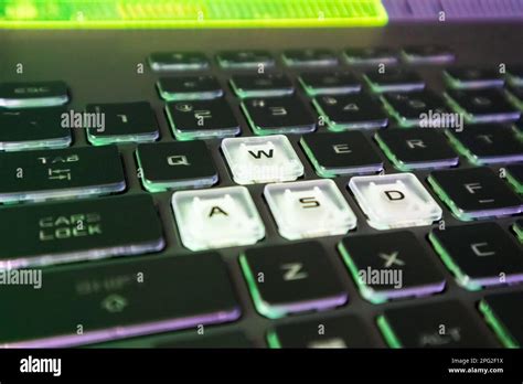 Highlighted Gaming Keys With Green And Purple Light Powerful Dark Notebook Keyboard Close Up