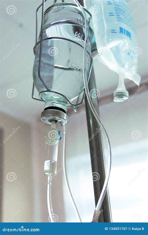 An Intravenous Infusion On A Rack Dripping In A Ward Among Ther Medical