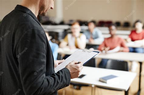 Premium Photo Closeup Of Male College Professor Checking Notes While