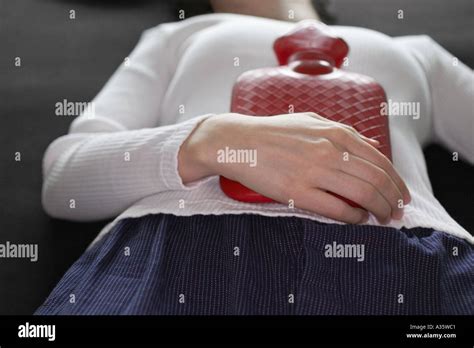 Woman Holding Hot Water Bottle On Stomach Stock Photo Alamy