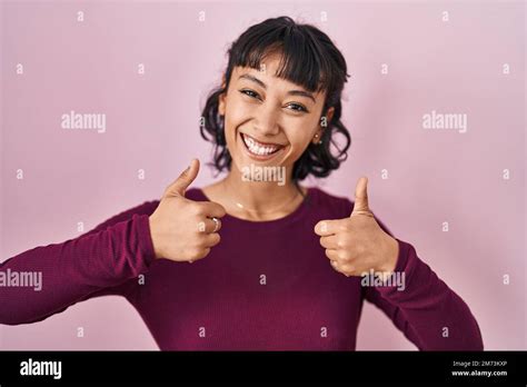 Young Beautiful Woman Standing Over Pink Background Success Sign Doing
