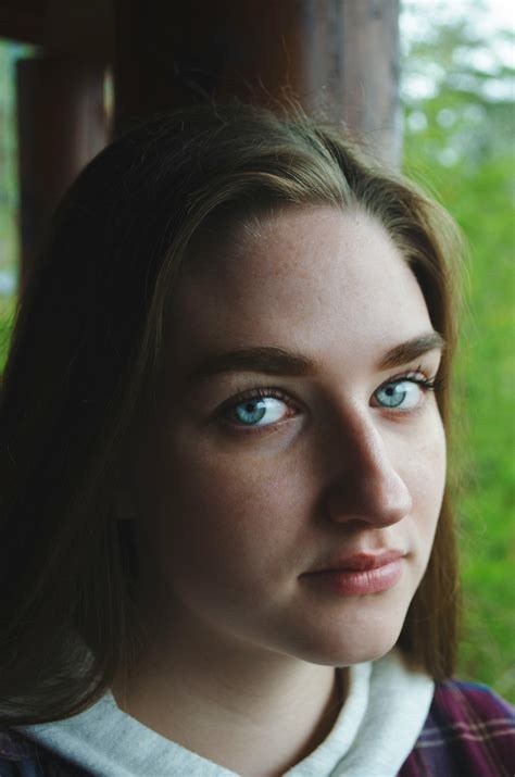Girl With Brown Curly Hair And Blue Eyes