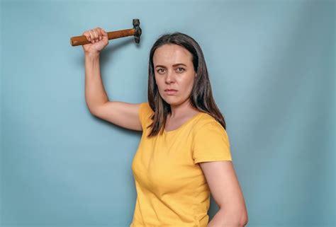 Premium Photo Woman Holds In Her Hands And Swings A Hammer At The Viewer Female Anger