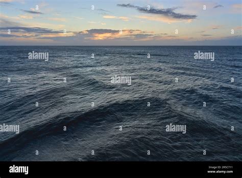 A Horizontal Oriented Photograph Of Sea Waves Under An Early Morning