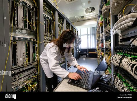 Female Engineer On Laptop Fixing Some Problems In A Server Room Stock