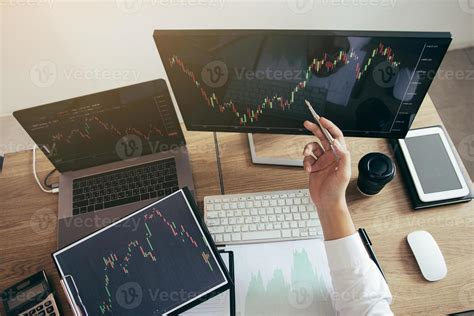 Investor Man Analyzing The Graph Of The Stock Market Using A Pen
