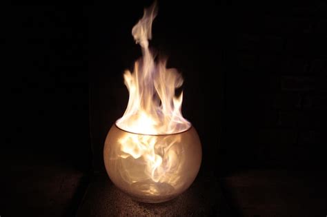 Premium Photo Fire In Container Against Black Background