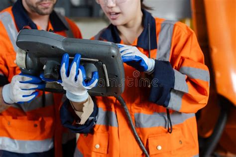 Close Up Woman Engineer Using Remote Robot Controller Operate Standing