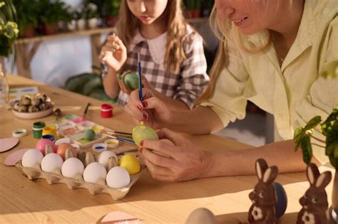 Premium Photo Creative Mom And Daughter Working With Easter Eggs