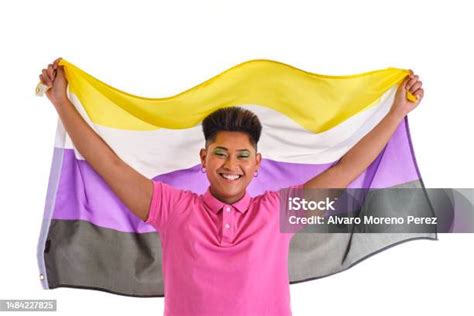 Non Binary Asian Person Smiling In Pink Shirt Holding Nonbinary Gender