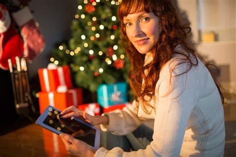 Premium Photo Redhead Woman Sitting On Floor Using Tablet At Christmas