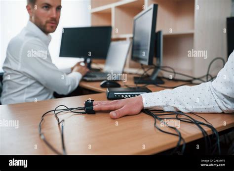 Tell Me Yes Or No Suspicious Man Passes Lie Detector In The Office Asking Questions Polygraph