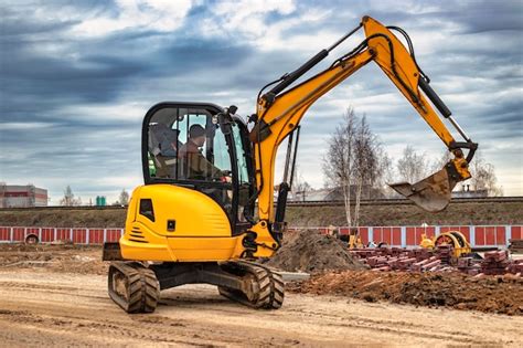 Premium Photo Mini Excavator At The Construction Site On The Edge Of