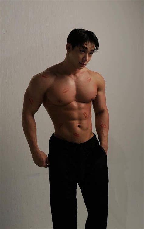 A Man Without A Shirt Standing In Front Of A White Wall With His Hands On His Hips