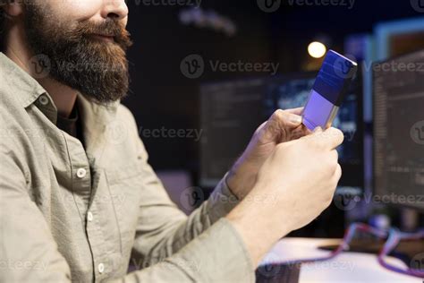 programmer inserting disk into desktop pc containing data able to create sentient ai close up