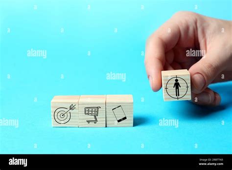 Professional Buyer Woman Putting Wooden Cube With Human Icon On Light Blue Background Closeup
