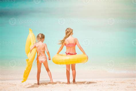 Little Happy Funny Girls Have A Lot Of Fun At Tropical Beach Playing