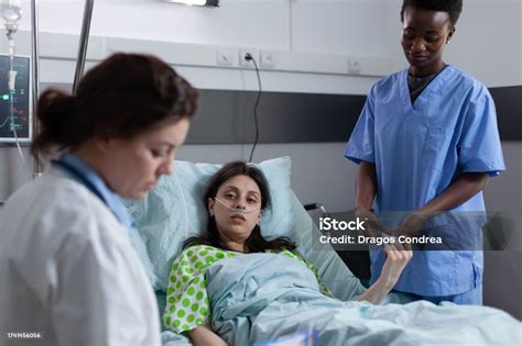 Nurse Measuring Spo2 Saturation Using Pulse Oximeter On Patient Finger
