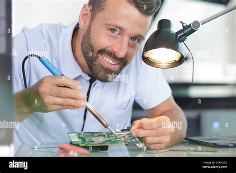 Man Soldering A Circuit Board Stock Photo Alamy