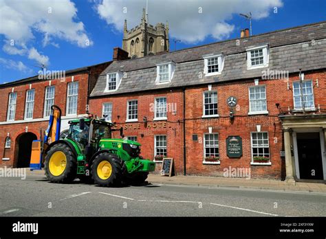 John Deer Tractor Passing The Castle Hotel Devizes Wiltshire Stock