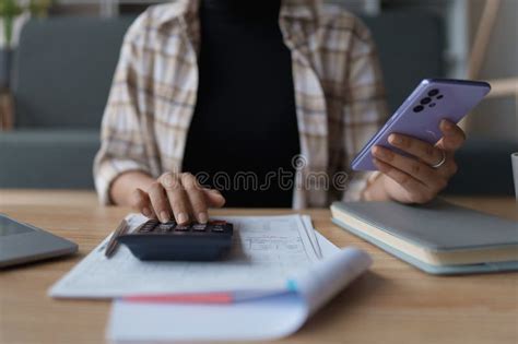 Smart Mortgage Planning Woman Using A Calculator To Make Calculations And Consideration Stock