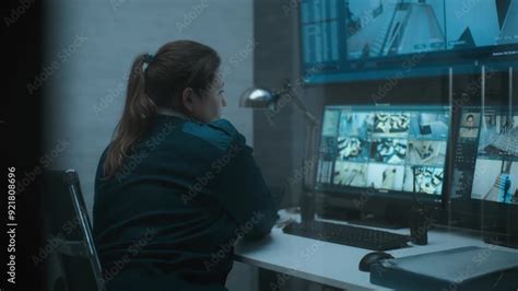 Female Surveillance Operator Controls Security Cameras With Face Recognition In Monitoring