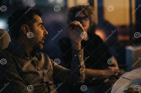 Successful Business People Collaborating And Strategizing In An Evening
