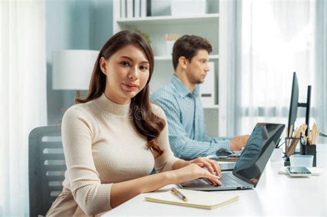 Woman Working On Laptop Taking Note To Pose For Looking At Camera Postulate Stock Image