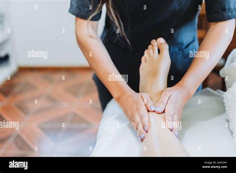 Unrecognizable Therapist Making A Foot And Leg Massage To A Female Patient Wellness Center Spa