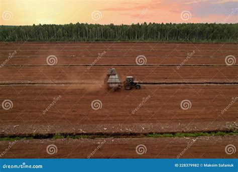Peat Harvester Tractor On Collecting Extracting Peat Mining And Harvesting Peatland Area