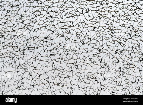 macro closeup of a broken glass window cracks run throughout the glass