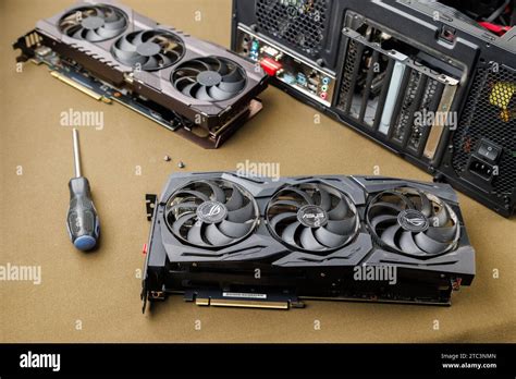 Graphics Card Upgrading Concept Two Gaming Graphics Cards Near Desktop Miditower ATX Pc Case On
