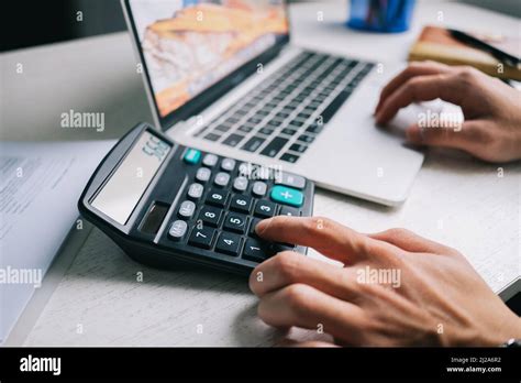 Asian Businessmen Use A Calculator To Calculate Tax And Income Stock