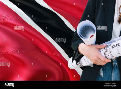 Architect Woman Holding Blueprint Against Trinidad And Tobago Waving