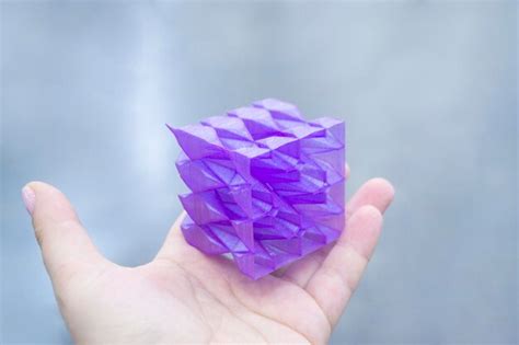Premium Photo Person Holding A Abstract Model Printed On A D Printer From Purple Plastic On