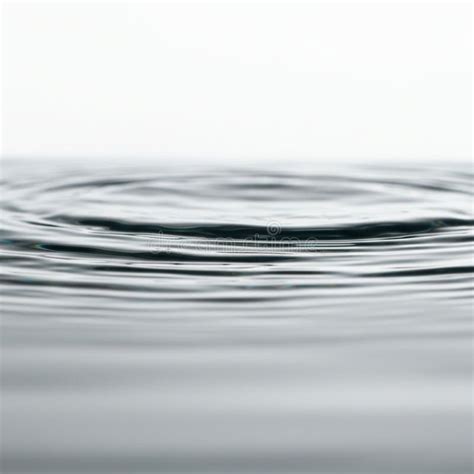 Circular Ripples Gently Spread Across A Smooth Water Surface Creating A Sense Of Stock