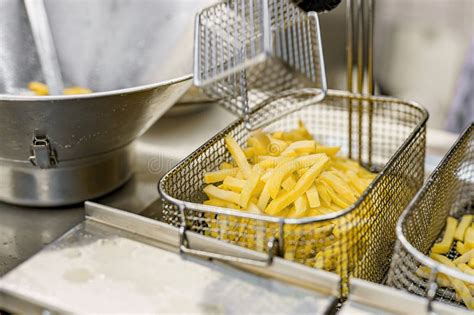 Cooking French Fries Before Frying Them In Oil At A Fast Food