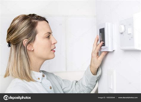 Woman Set The Thermostat At House Stock Photo By Lopolo 165035544