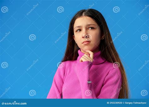 Young Teen Girl Thinking About Something Over Blue Background Stock