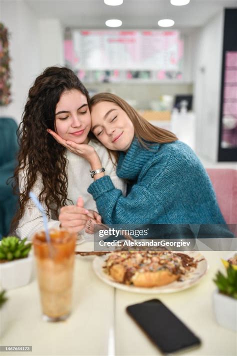 Cute Lesbian Female Touching Girlfriends Face And Offering Her Waffles