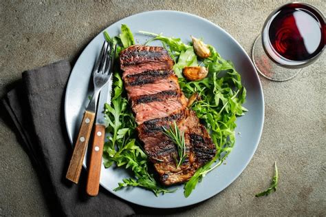 Premium Photo Grilled Ribeye Beef Steak With Red Wine Herbs And Spices Top View Flat Lay